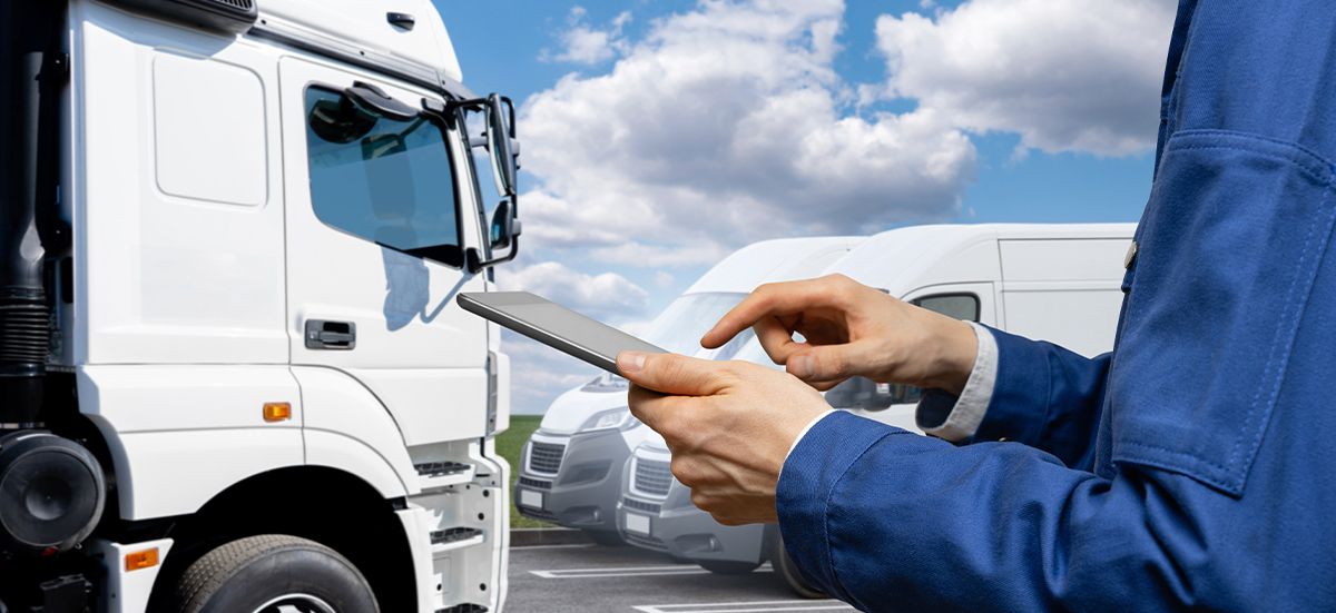 Fleet manager using digital tablet to monitor trucks and manage fleet ...